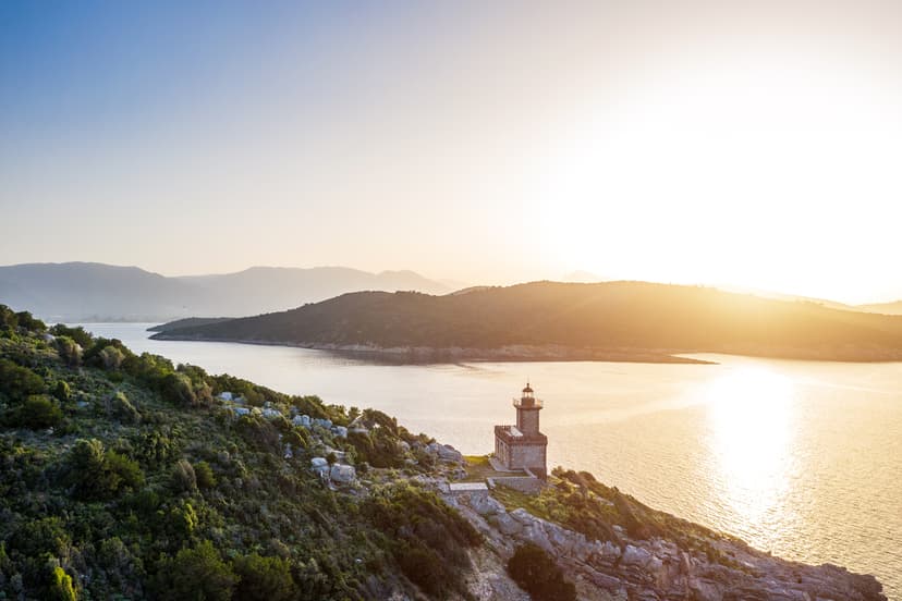 Aerial view of Poros, Greece, with Dana lighthouse at sunset. Backlight ...